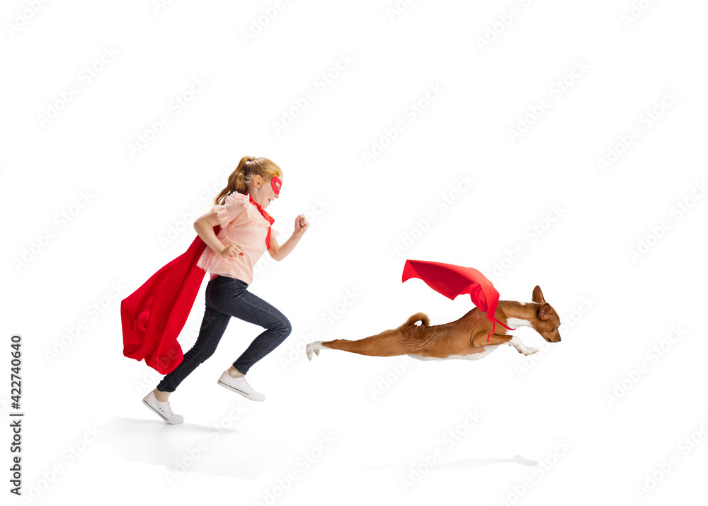 Child pretending to be a superhero with her super dog isolated on white ...