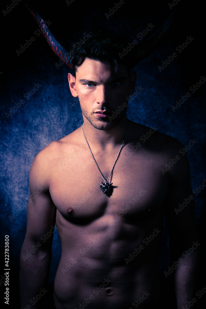 Sexy shirtless male devil with horns and muscular body showing pecs and ...