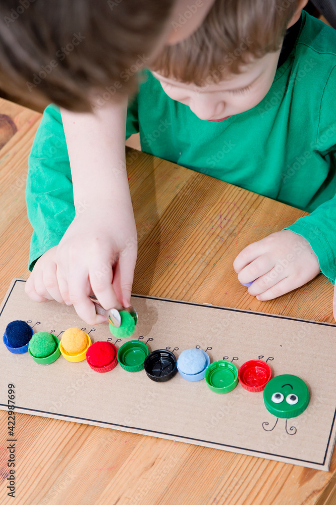 Plastic bottle caps worm. Put correct color pom poms in centipede ...