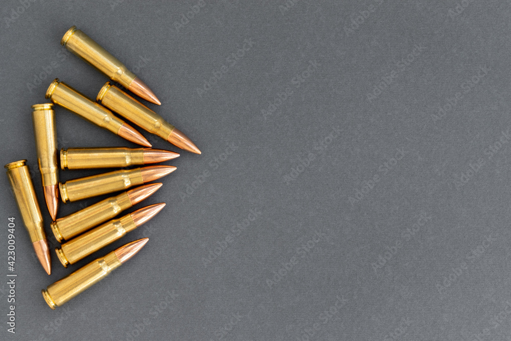 Group of bullets on gray paper background. Cartridges 7.62 caliber for ...