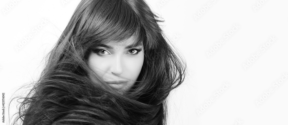 Monochrome beautiful woman with long shiny healthy black hair swept ...