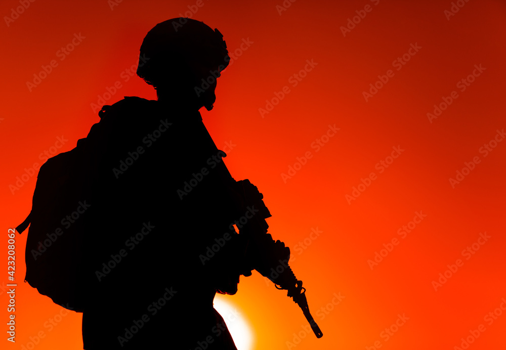Silhouette of army rifleman in helmet and ammunition, carrying tactical ...