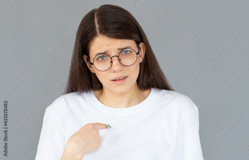 Headshot of young woman holding hand on her breast, verbally defending ...