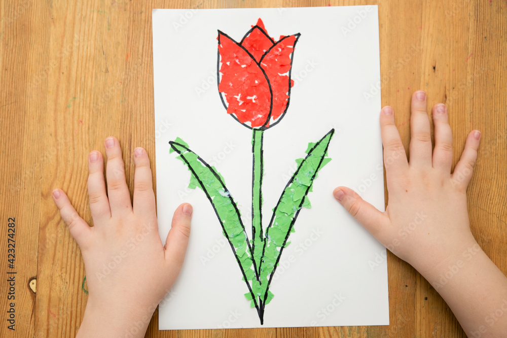 Mothers day theme. Paper tulip application. Boy making color paper ...