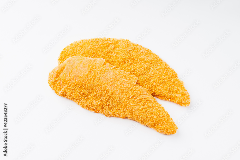 Raw chicken fillet inner, sprinkled with bright breading.Two slices of ...