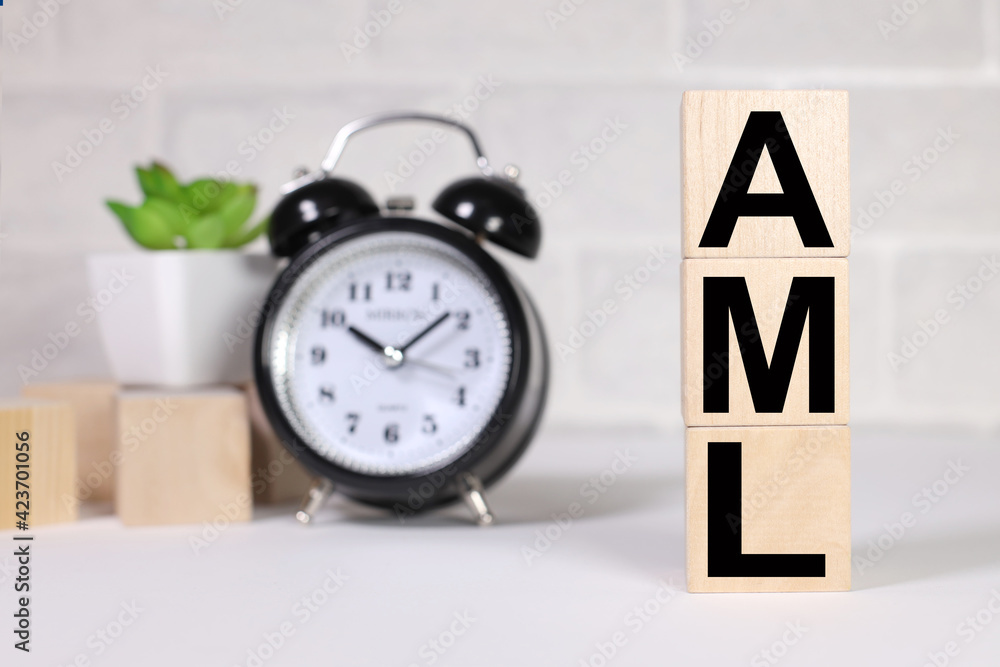 Anti-money laundering AML. text on wood cubes. text in black letters on ...