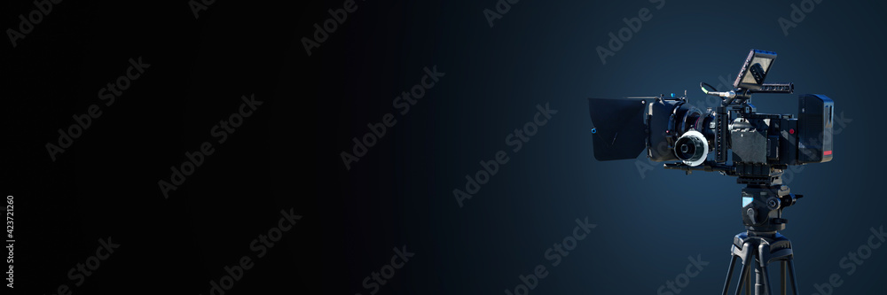 Professional digital movie camera on dark blue background. Television ...