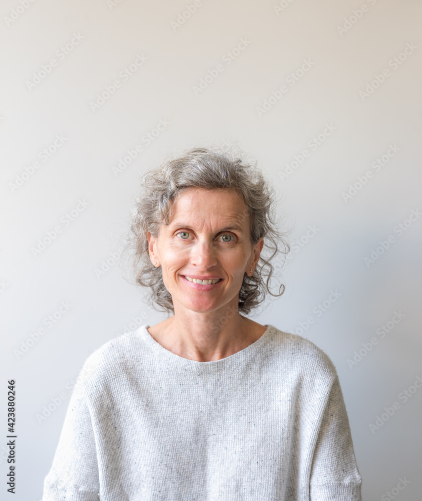 Head and shoulders view of casually dressed middle aged woman with grey ...