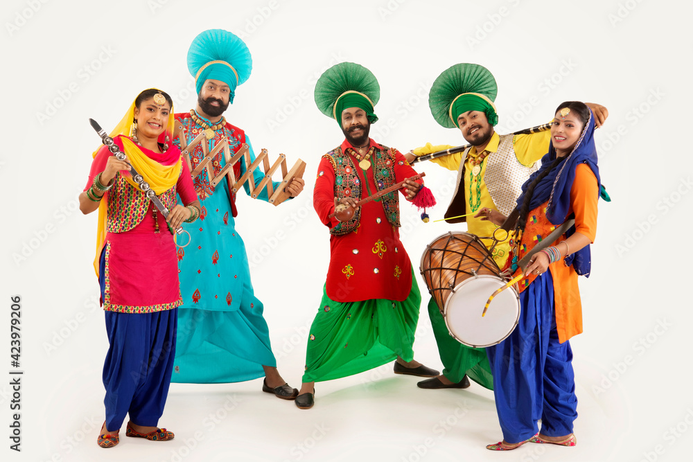 A Troupe of Punjabi Folk dancers dressed in costume with Dhol,Khunda ...