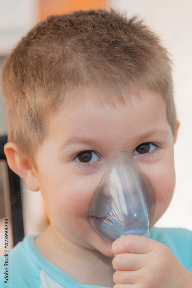 Little boy using nebulizer during inhaling therapy. Little boy making ...