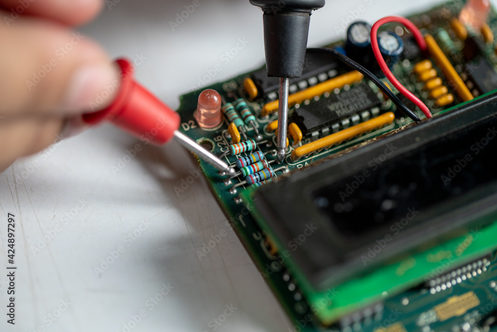 Using a multimeter to measure resistance on the resistor. Stock Photo ...