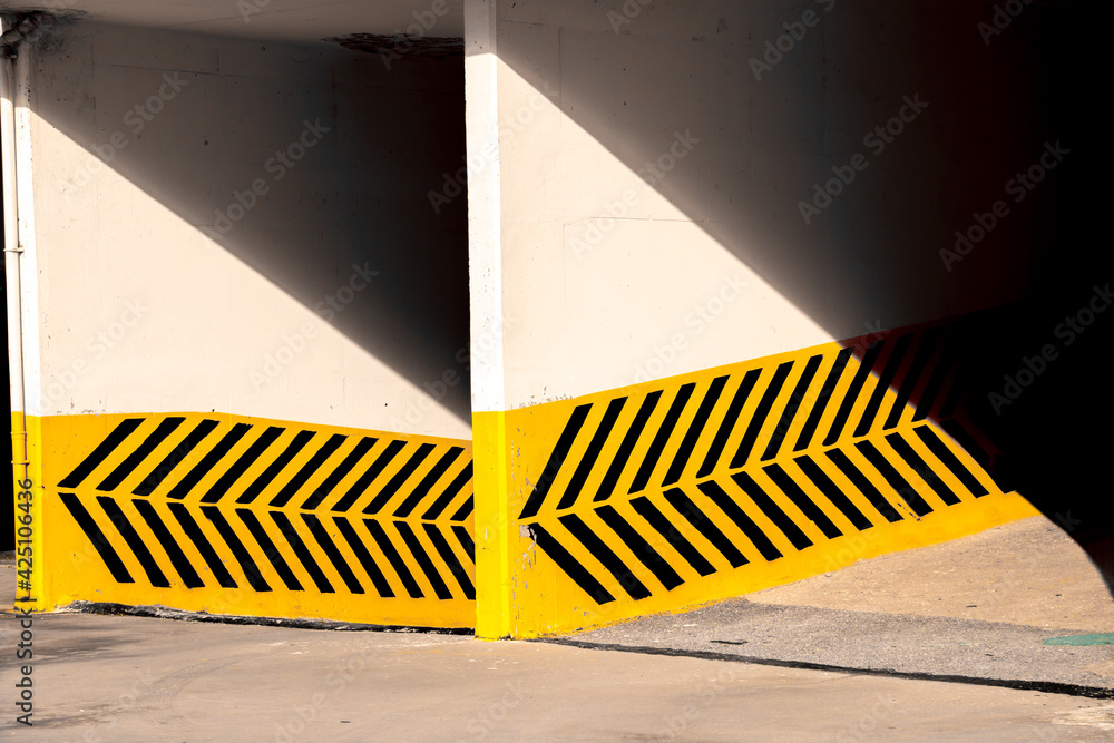 yellow and black traffic signs. Yellow dashed lines indicating the ...