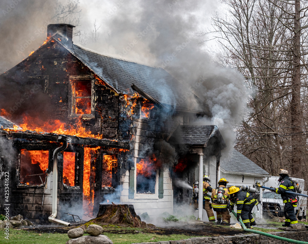 firefighters fighting house fire Stock Photo | Adobe Stock