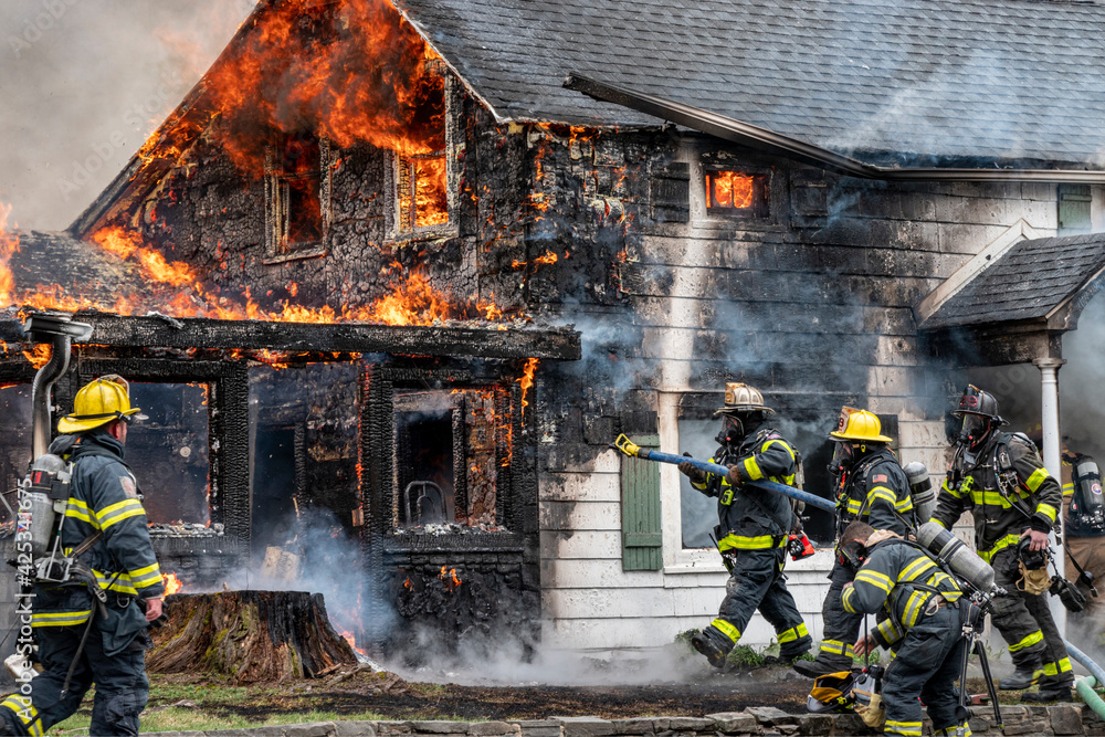 firefighters fighting house fire Stock Photo | Adobe Stock