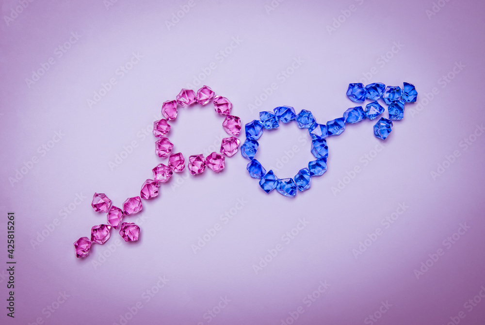 Male and female gender symbols made of gemstones or colorful crystals ...