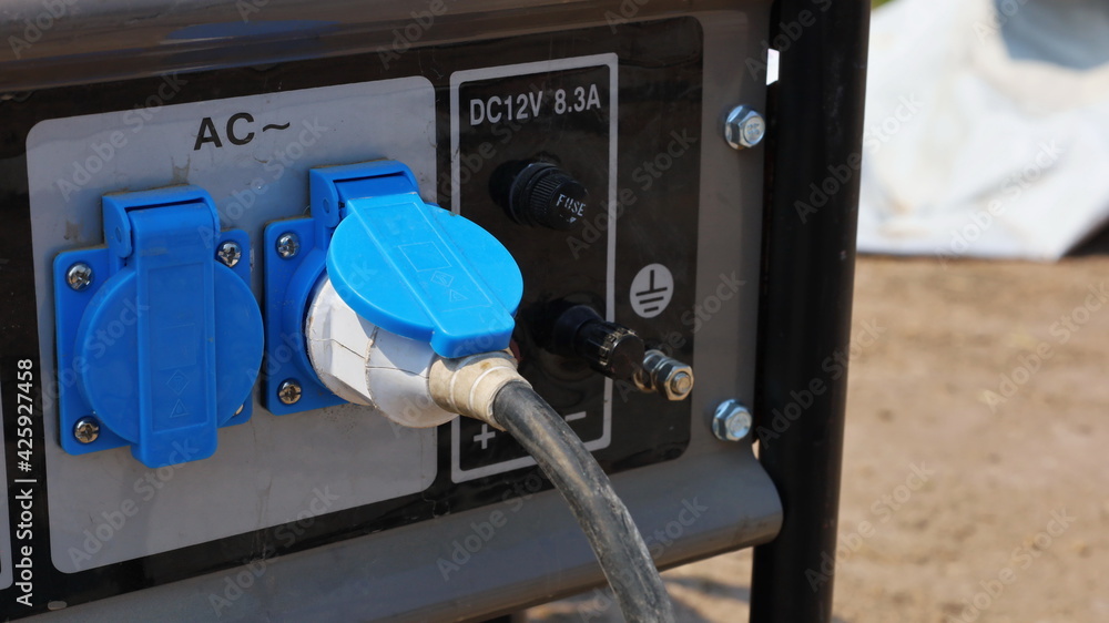 Electrical socket connected to the generator plug. Power cord that ...