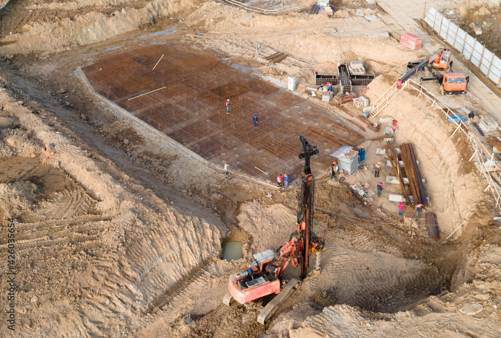Pile driver at construction site. Piles driven into the ground by ...