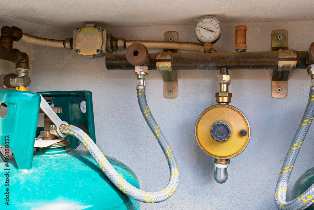 Foto Close up on one gas cylinder connected to the LPG regulator and to ...