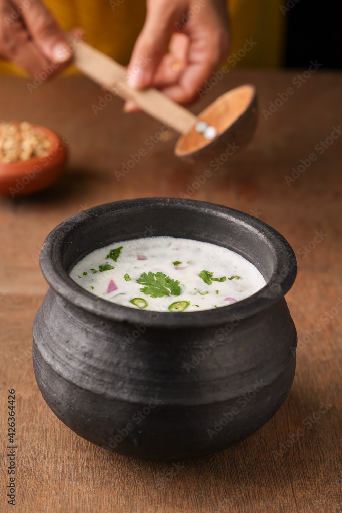 Serving spiced buttermilk , chaas , chaach , moru , sambharam , curd ...