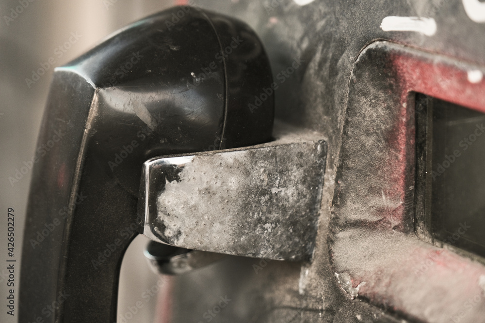 black push-button public payphone close-up, broken dusty vintage city ...