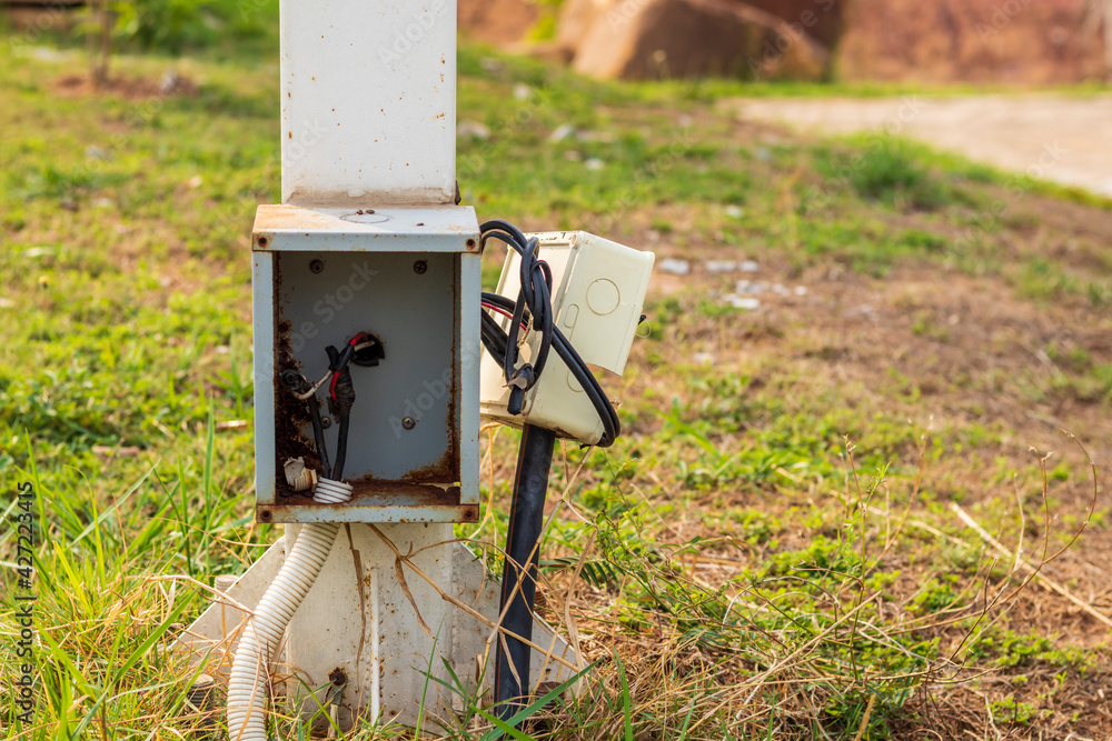 Unsafe condition concept. Uncovered rusted electric box, where electric ...