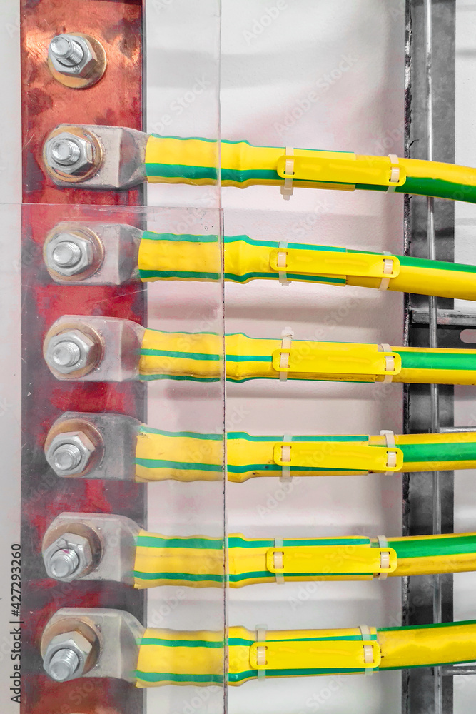 Electrical high voltage ground copper cables on wall. Grounding ...