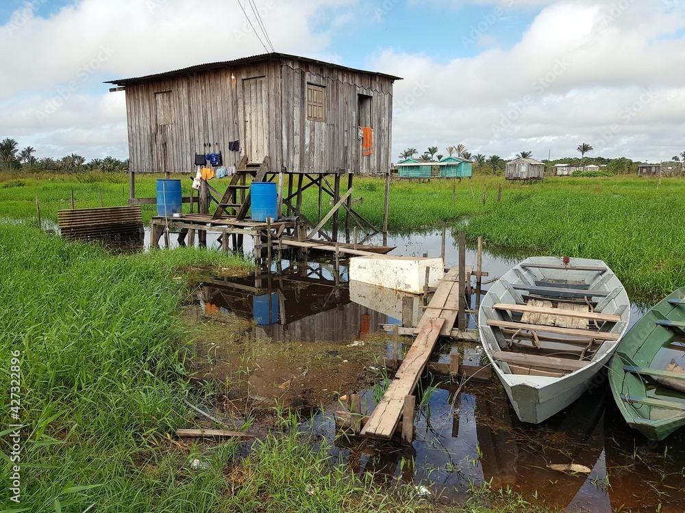 Wooden houses built on high stilts called in Portuguese palafitas. Near ...