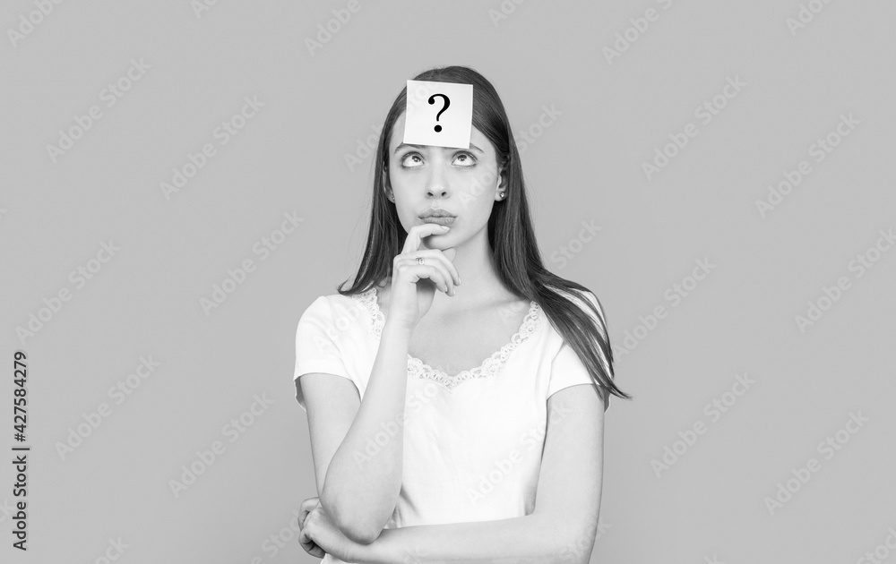 Confused female thinking with question mark on sticky note on forehead ...