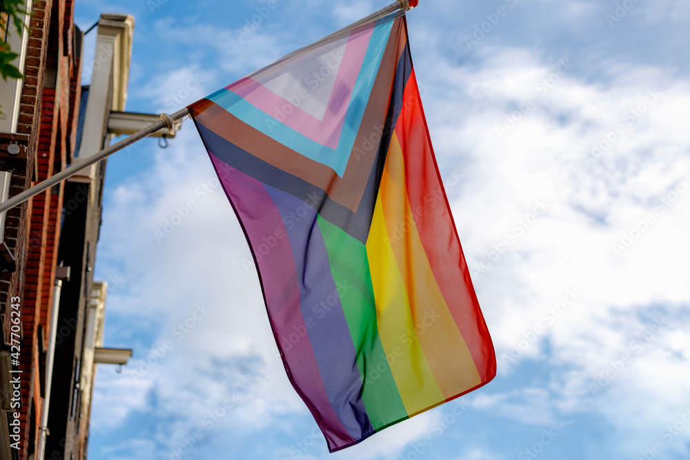 Celebration of pride month in Amsterdam, New rainbow flag hanging ...