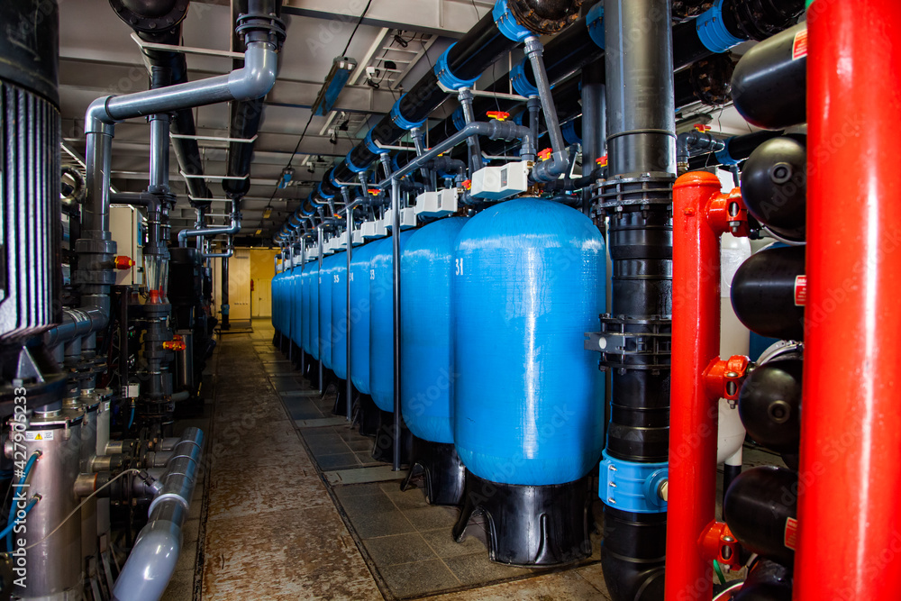 Modern water purification and filtration station. Machine room. Tanks ...