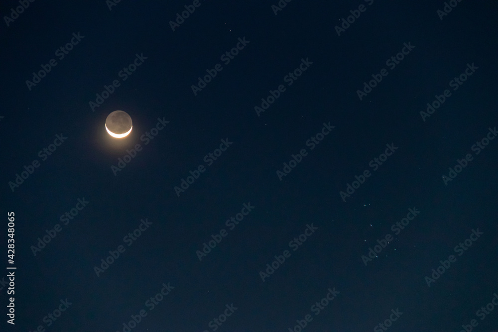 Crescent moon with earthshine is a soft, faint glow on the dark side of ...