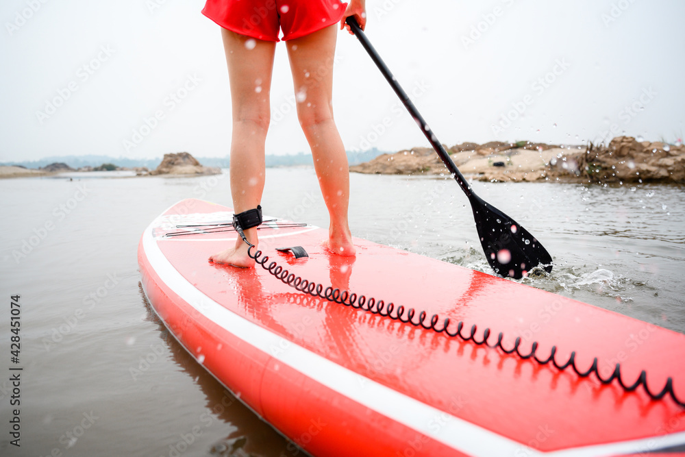 Stand up paddleboarding women paddle on the beach Happily on a ...