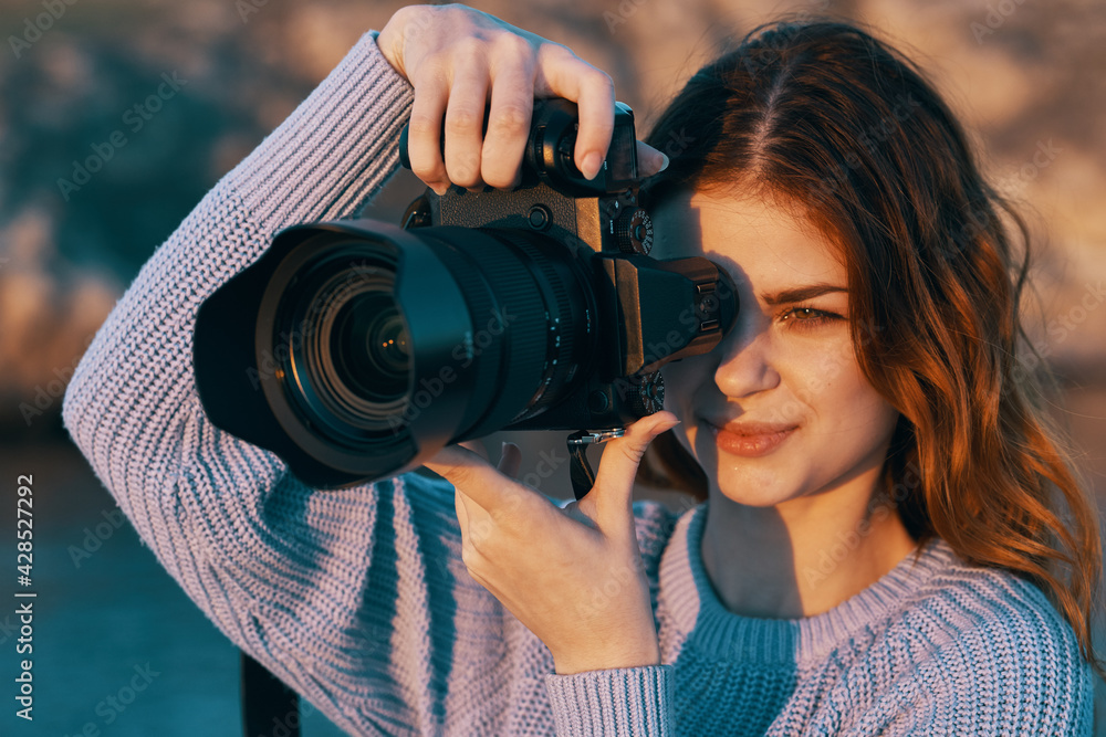 beautiful woman photographer on nature in the mountains photographs the ...