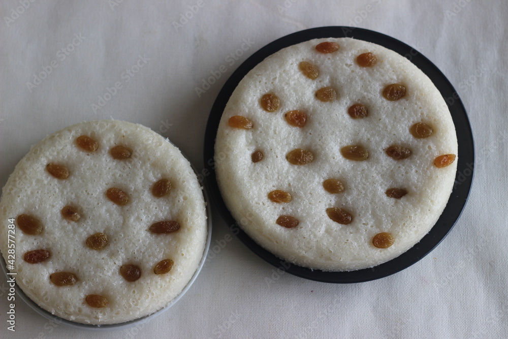 Spongy steamed rice cakes prepared with a fermented batter of rice and ...