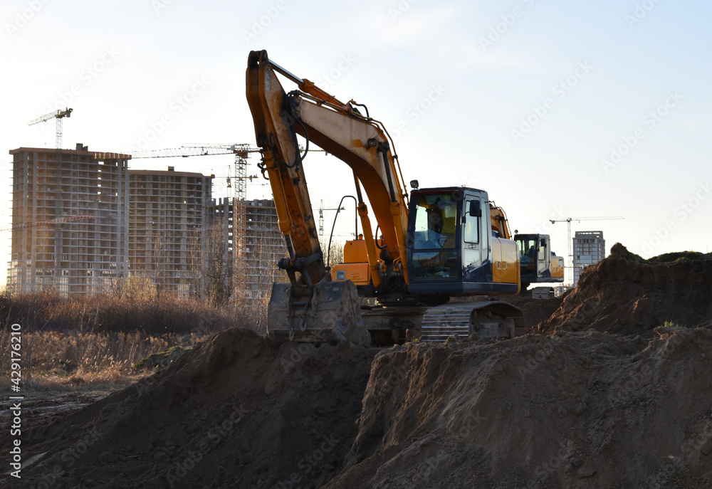 Excavator dig trench at construction site. Digging the pit foundation ...