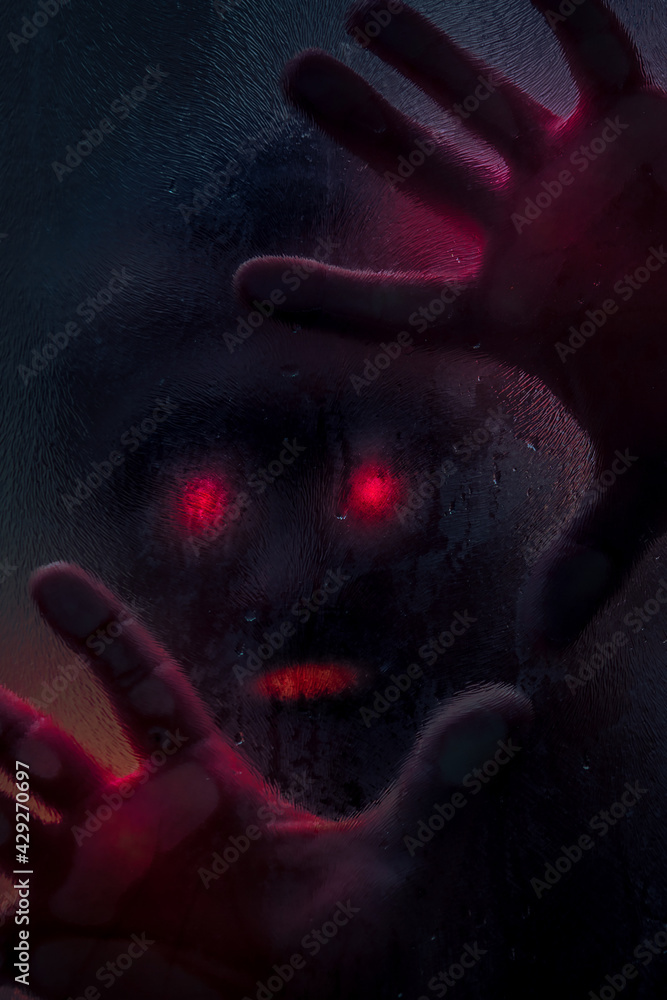 Horror scene of a man with bloody hand against wet shower glass. Toned ...