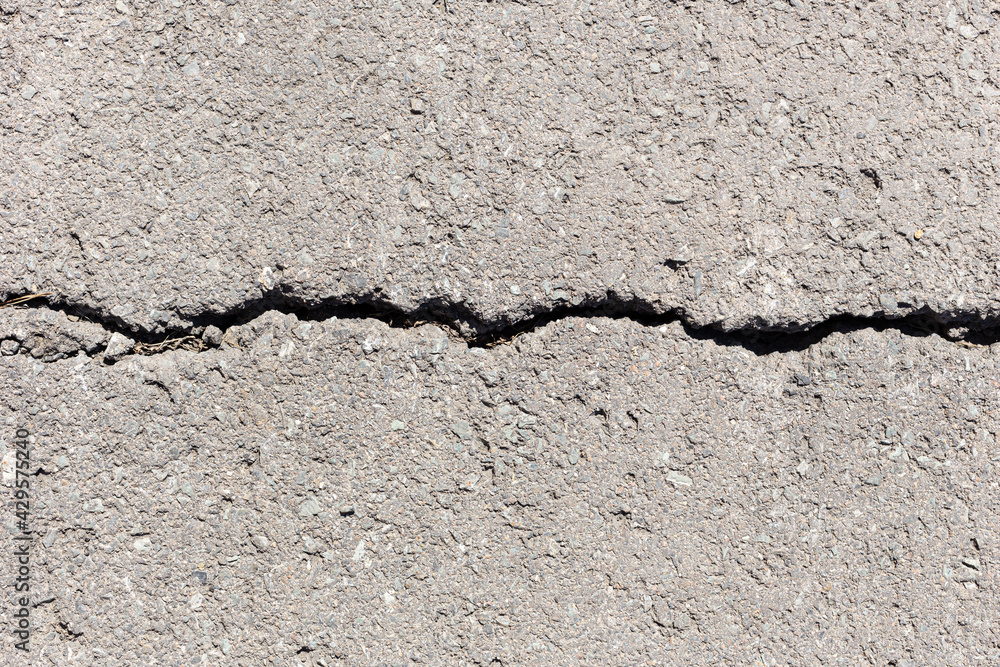 Foto de Stock Worn and cracked asphalt with big cracks. Old road ...