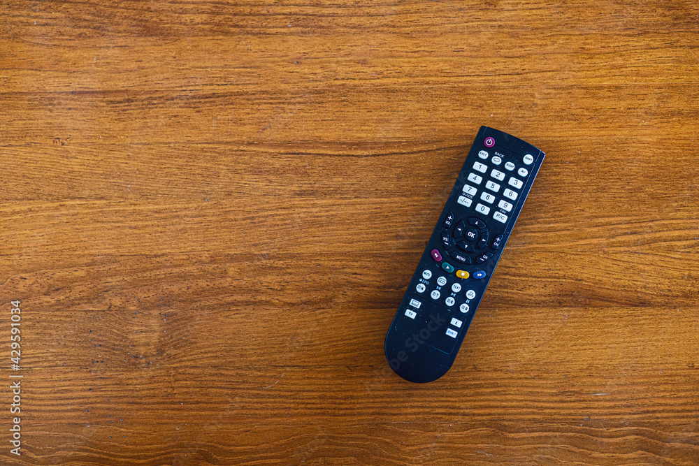 Foto de Stock remote control from the TV lying on a small table. wooden ...