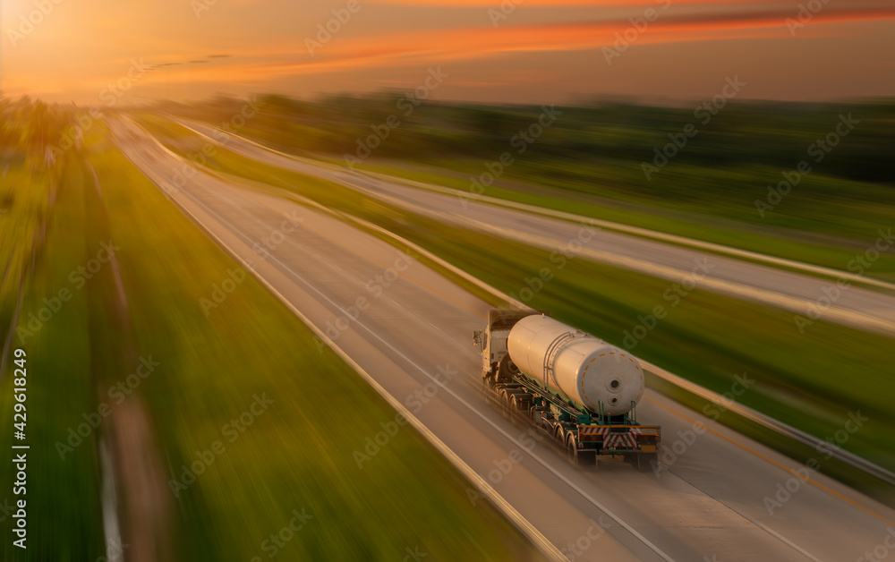 Gasoline tanker with fuel tanker truck shipping speed on high way road ...