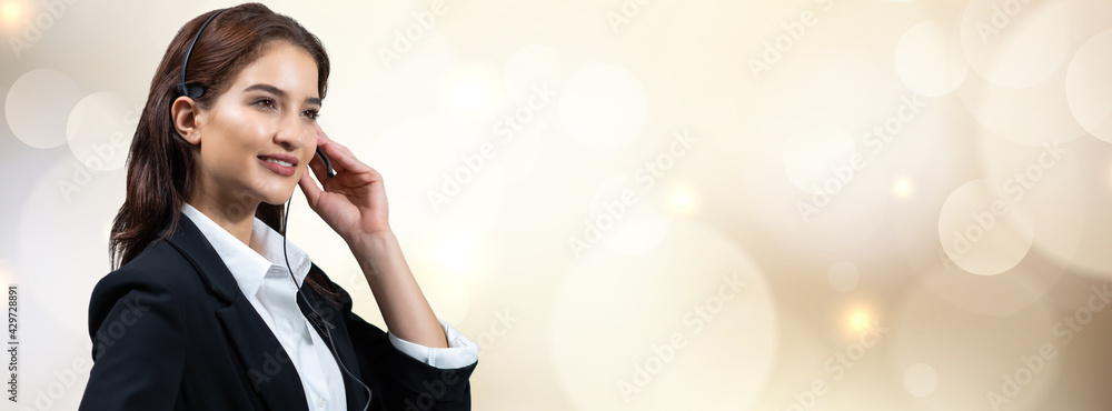 Attractive business woman in suits and headsets are smiling while ...