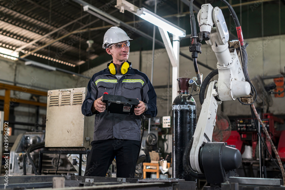 Robotics control engineers solve problems and setting programming of control panel for ...