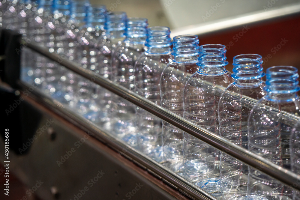 The PET bottles on the conveyor belt for filling process in the ...