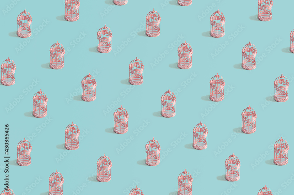 Pattern with pink closed bird cages against pastel blue background ...