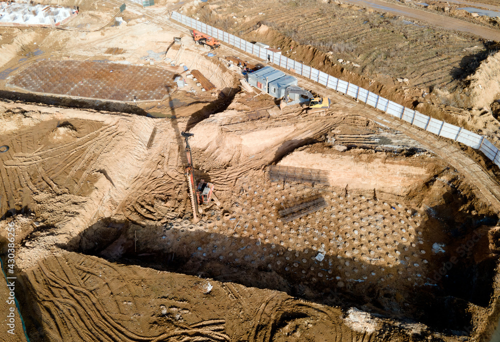 First floor slab rebar installation. Pile driver at construction site ...