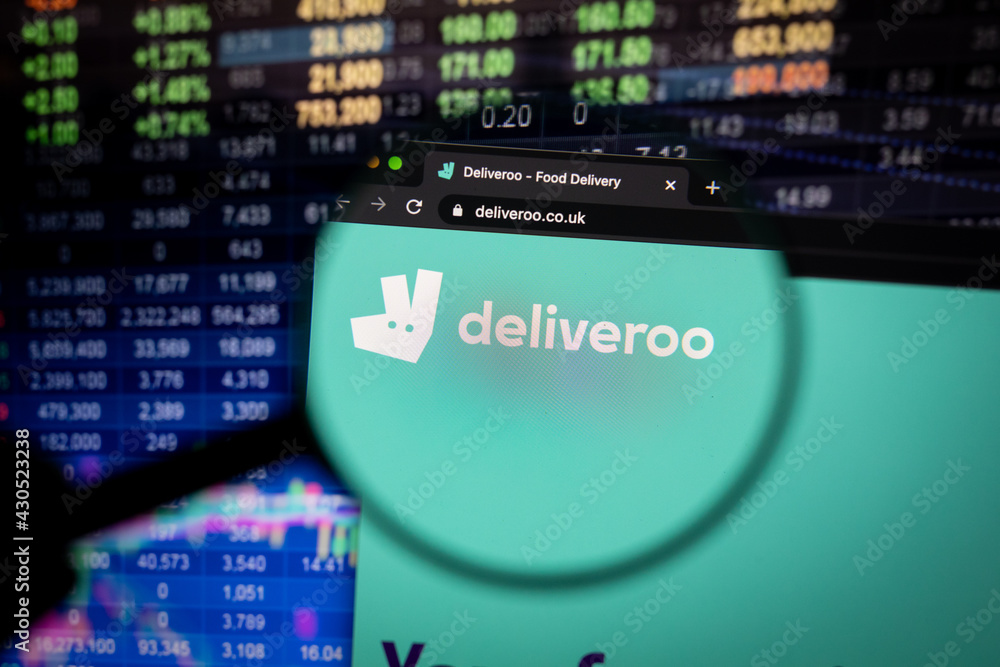 Deliveroo company logo on a website with blurry stock market developments in the background ...