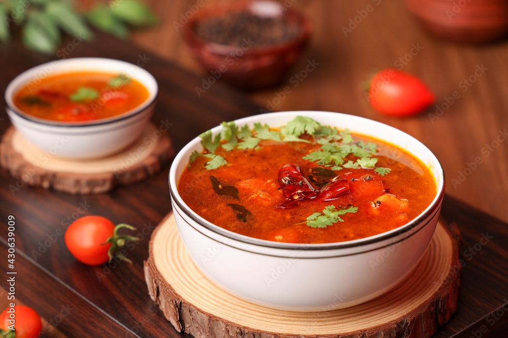 Tomato rasam curry hot spicy soup South Indian cuisine prepared using ...