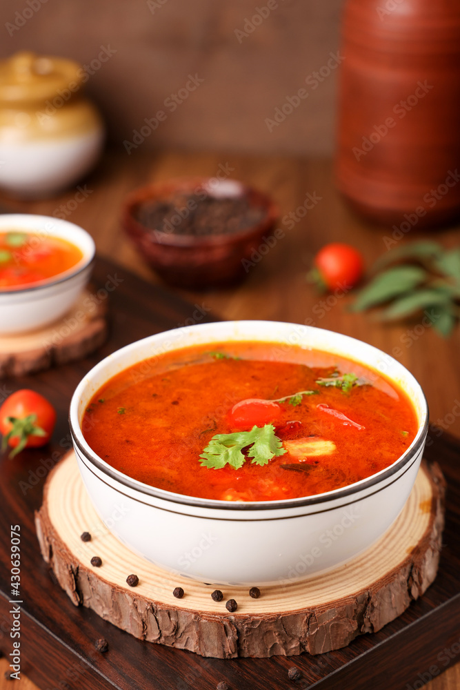 Tomato rasam curry hot spicy soup South Indian cuisine prepared using ...