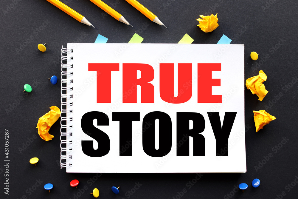 True story. Text on white paper on black background. and multi-colored ...