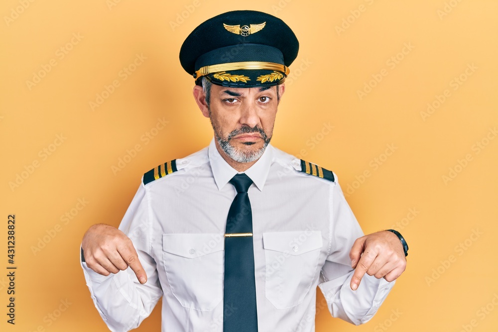 Handsome middle age man with grey hair wearing airplane pilot uniform ...