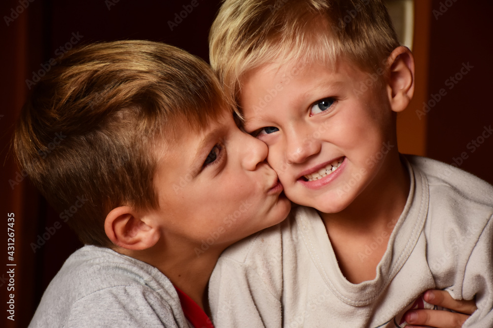 Closeup shot of a cheerful young Caucasian boy kissing his brother Stock Photo | Adobe Stock